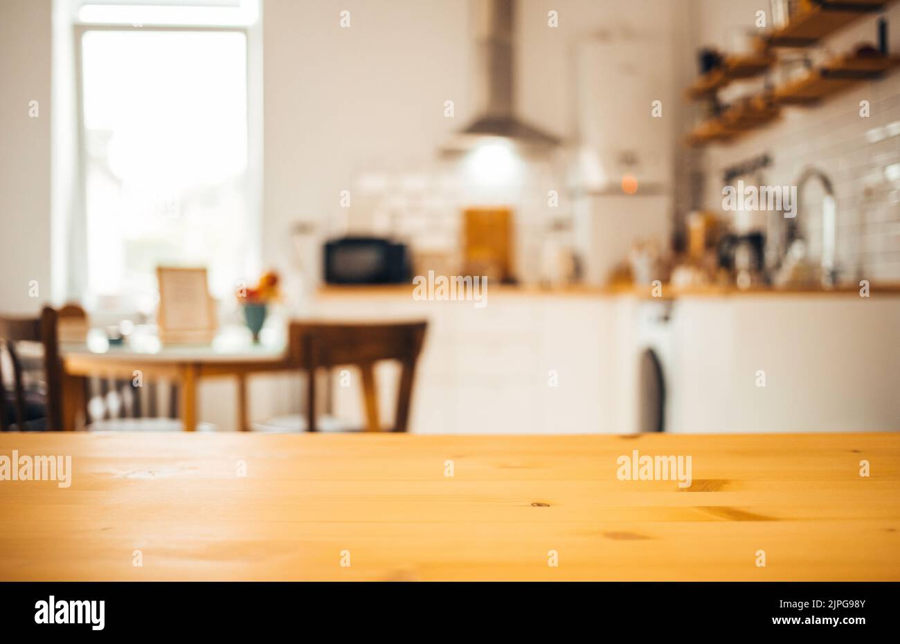 empty wooden tabletop and blurred kitchen mock up for product display ...