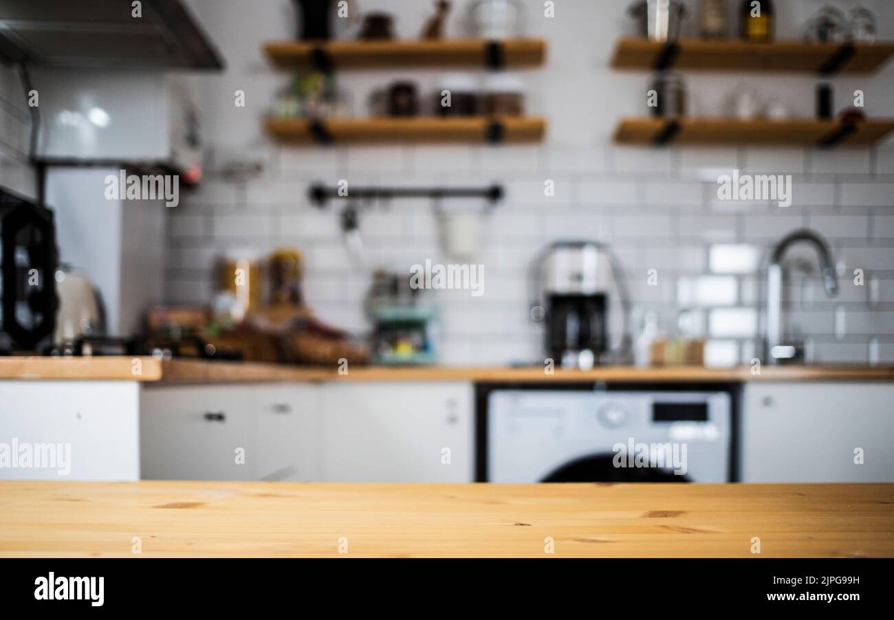 empty wooden tabletop and blurred kitchen mock up for product display ...