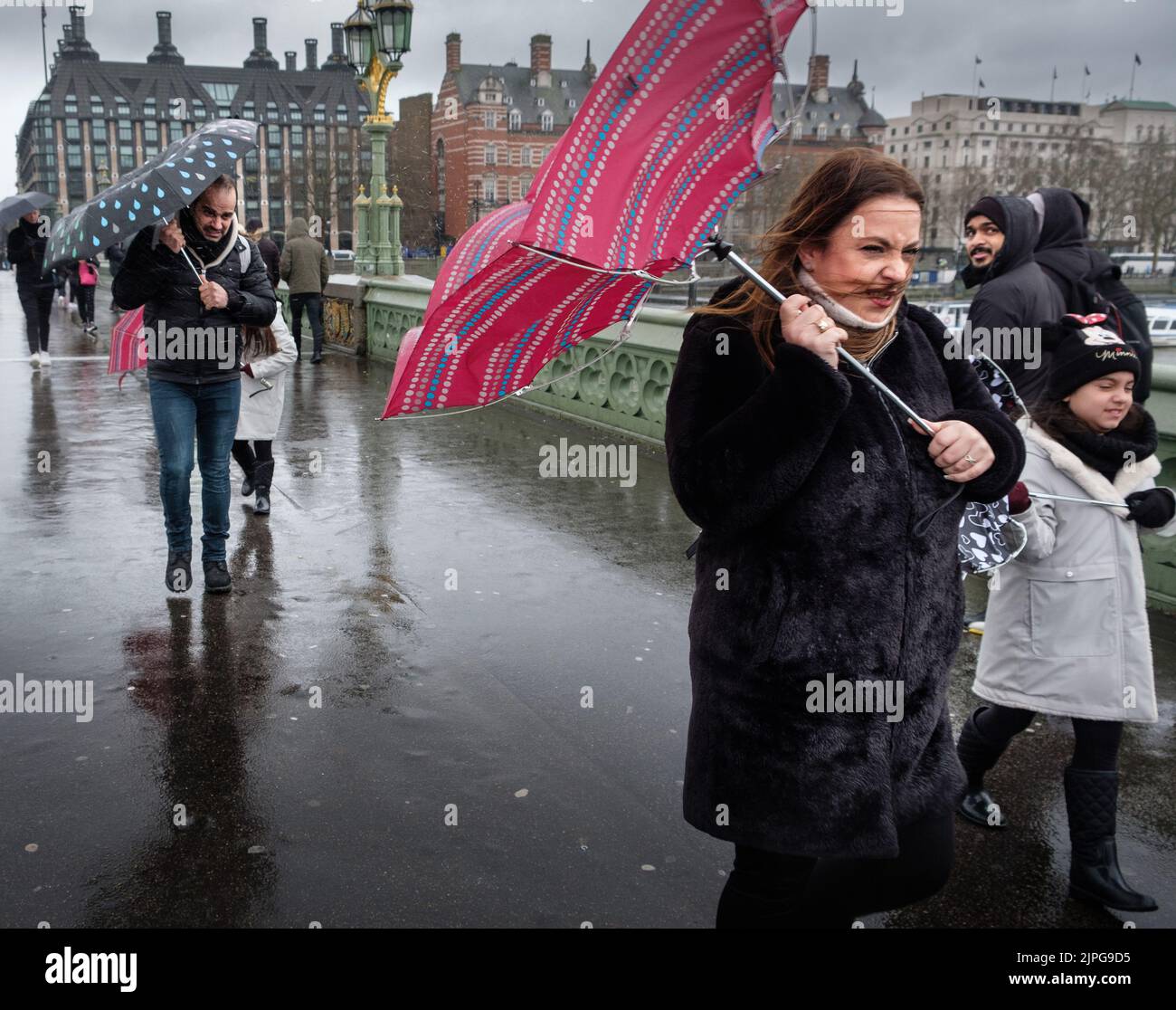 People in the wind and rain on Westminster Bridge Stock Photo - Alamy