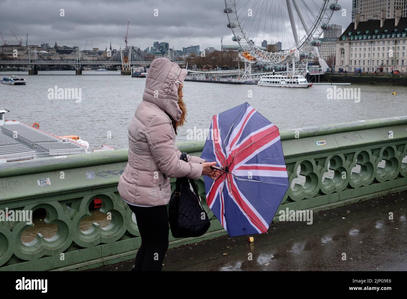 People in the wind and rain on Westminster Bridge Stock Photo - Alamy