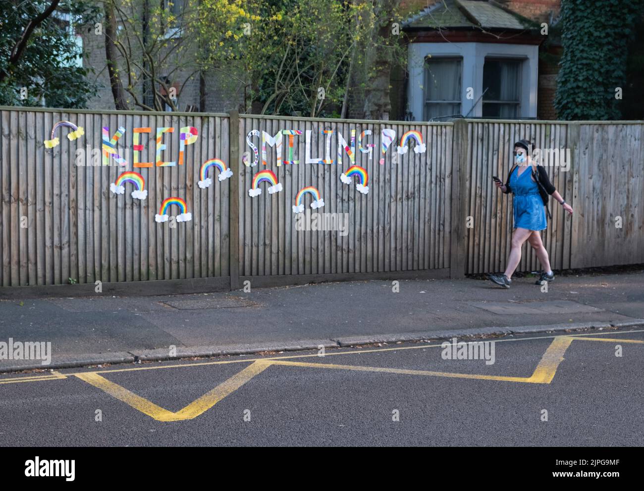 Masked walker and the NHS thank you "Keep Smiling" sign on Half Moon ...