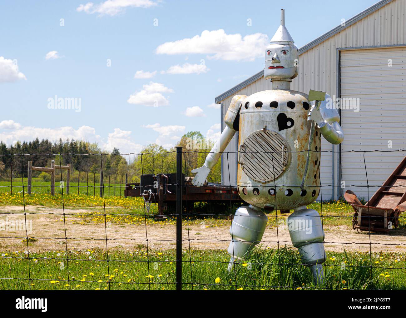 A steel robot guard with an ax behind a fence Stock Photo - Alamy