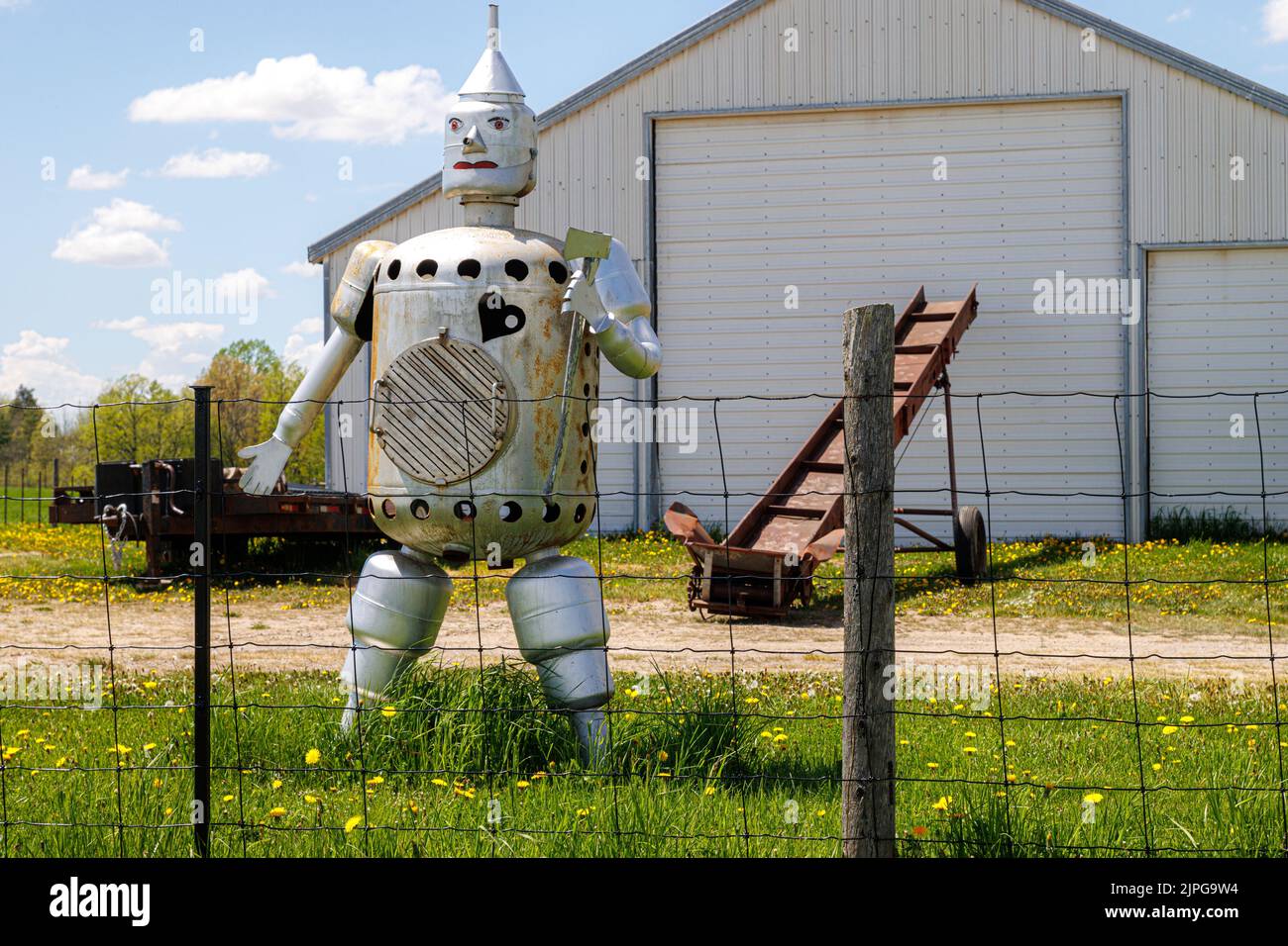 A steel robot guard with an ax behind a fence Stock Photo - Alamy