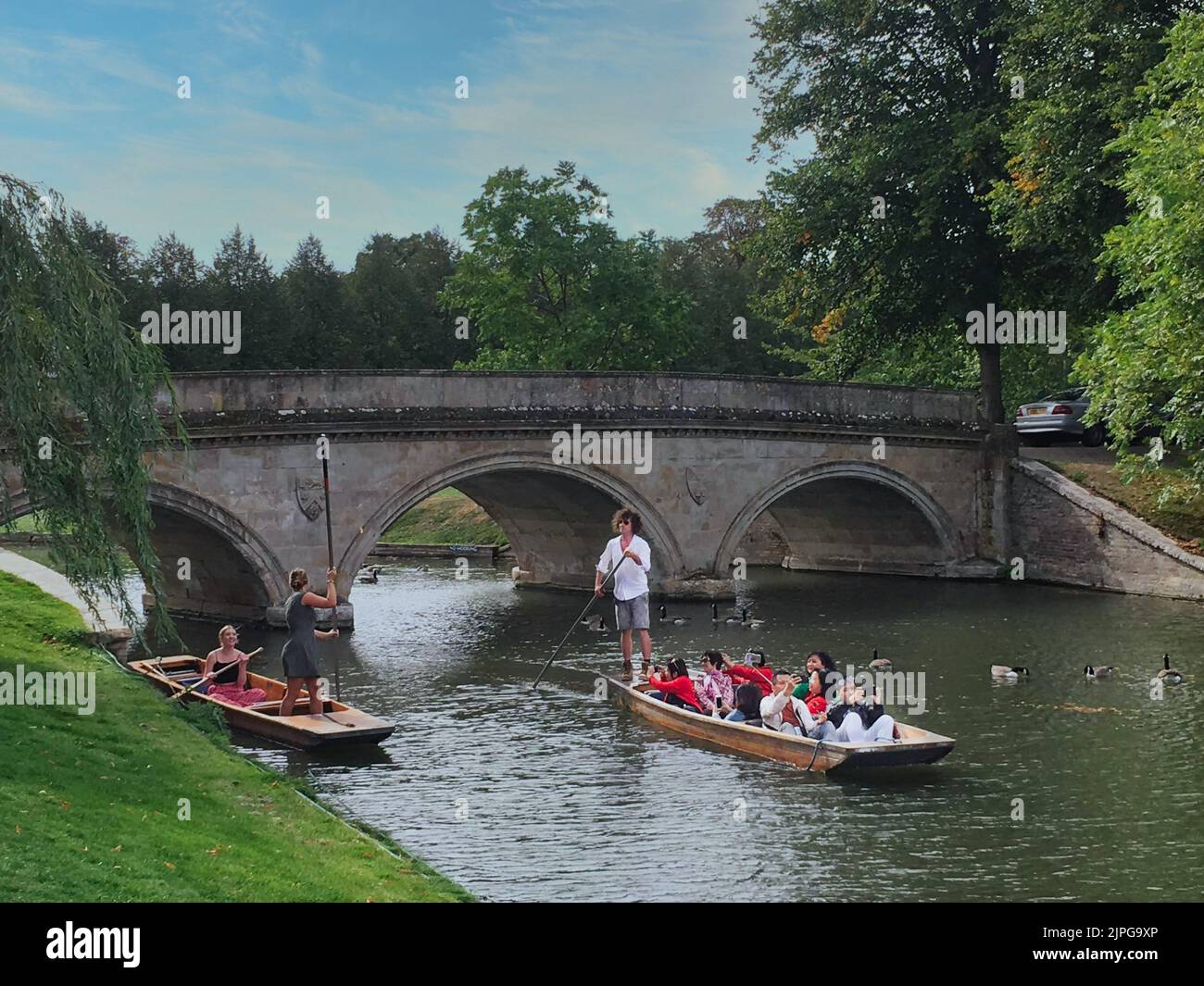 The Cambridge boat tours in a river against a scenic bridge in the ...