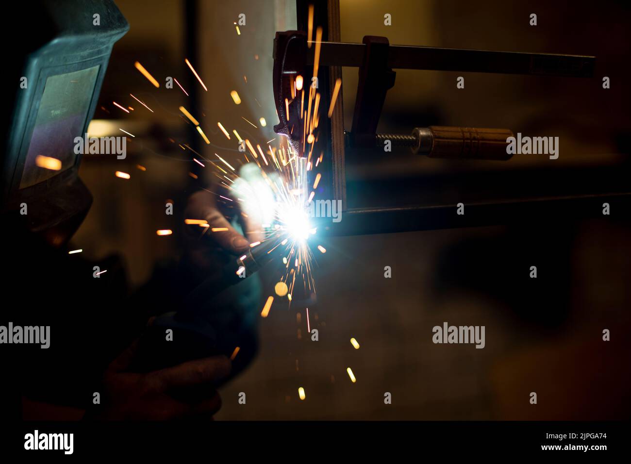 Welding work on metal. Blue fire from high temperature. Creation of ...