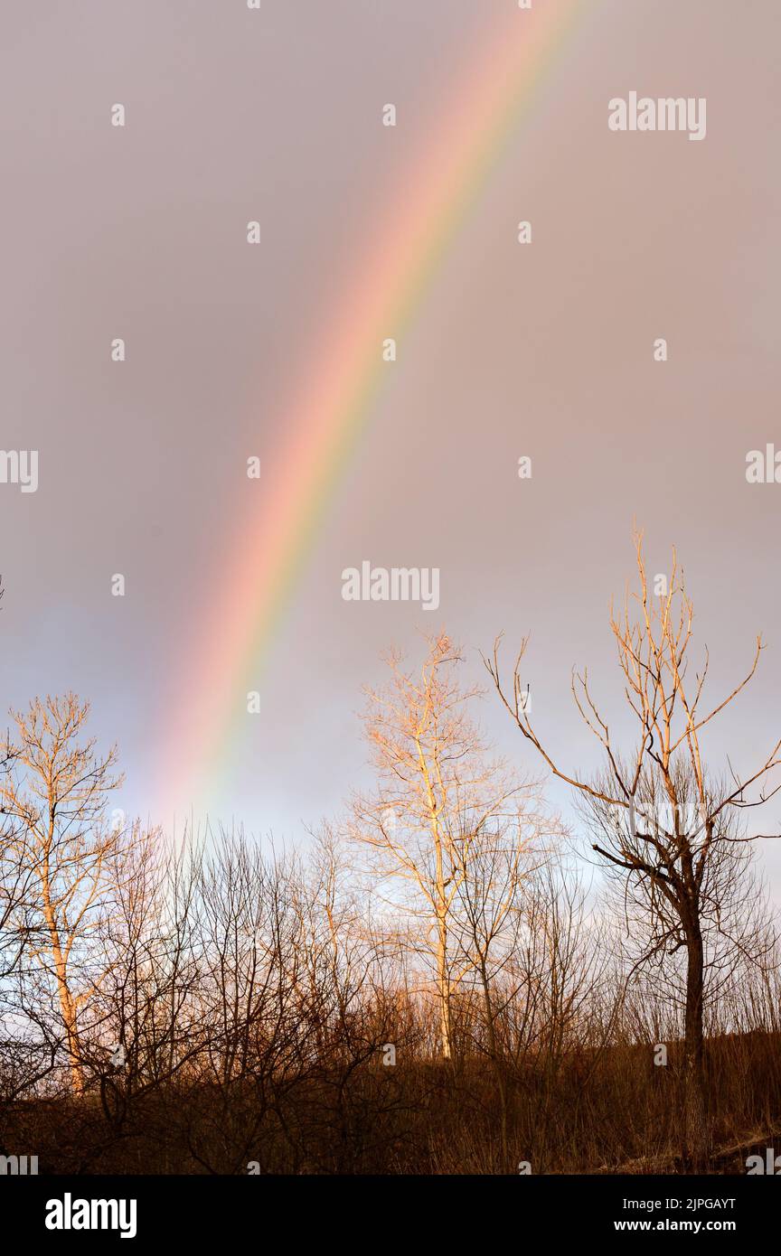 Rainbow in early spring in the Ukrainian village on a background of ...