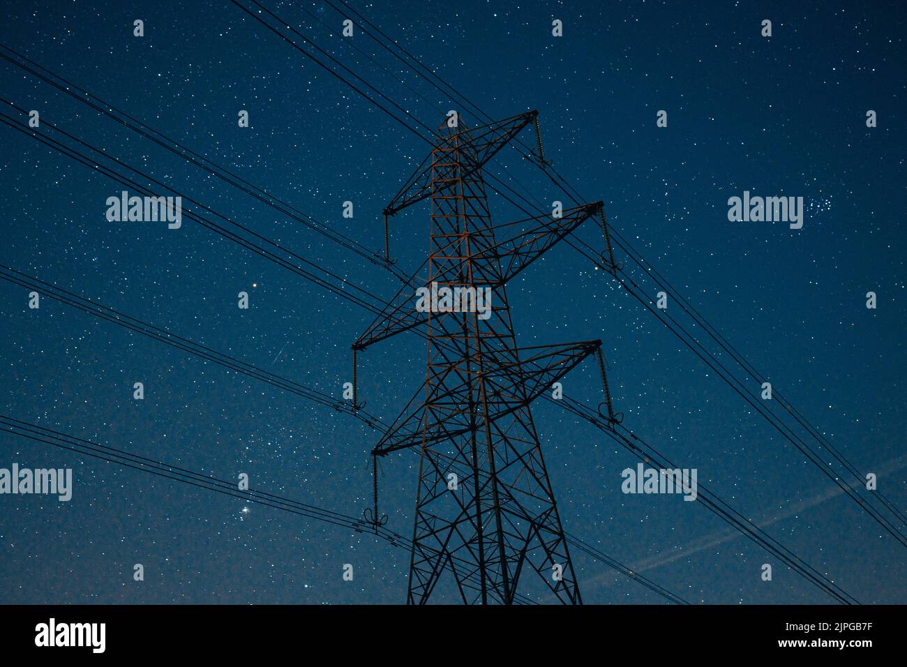 Newburn UK: March 2022: Looking up at electricity pylons on a clear ...