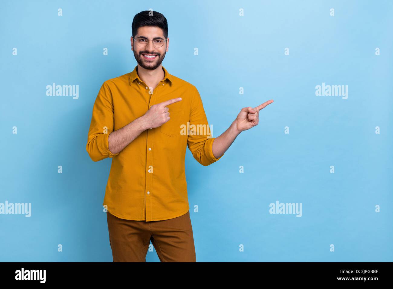 Photo of toothy beaming cheerful handsome man directing fingers at ...