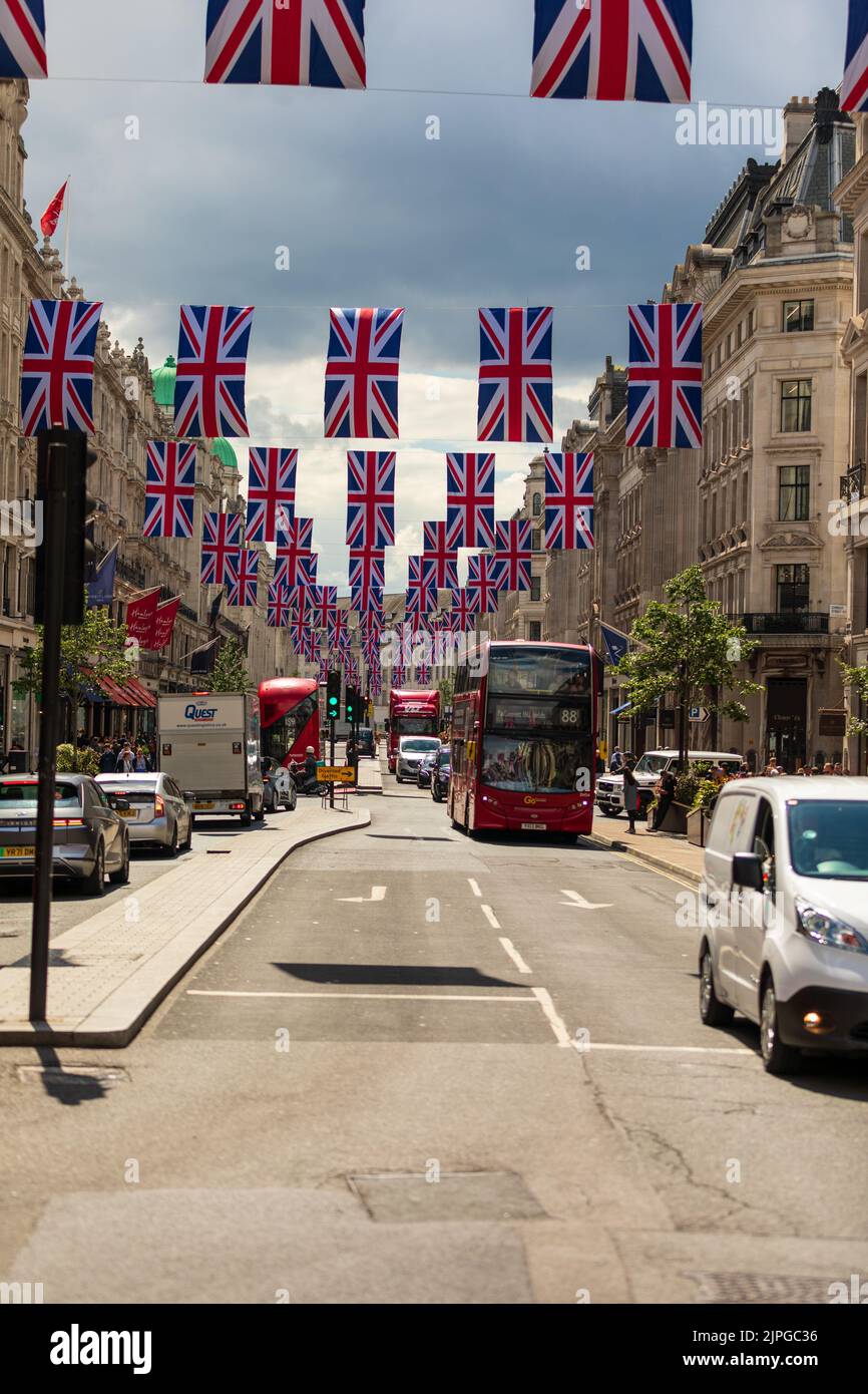 A vertical shot of British flags hanging on the street before the Queen ...