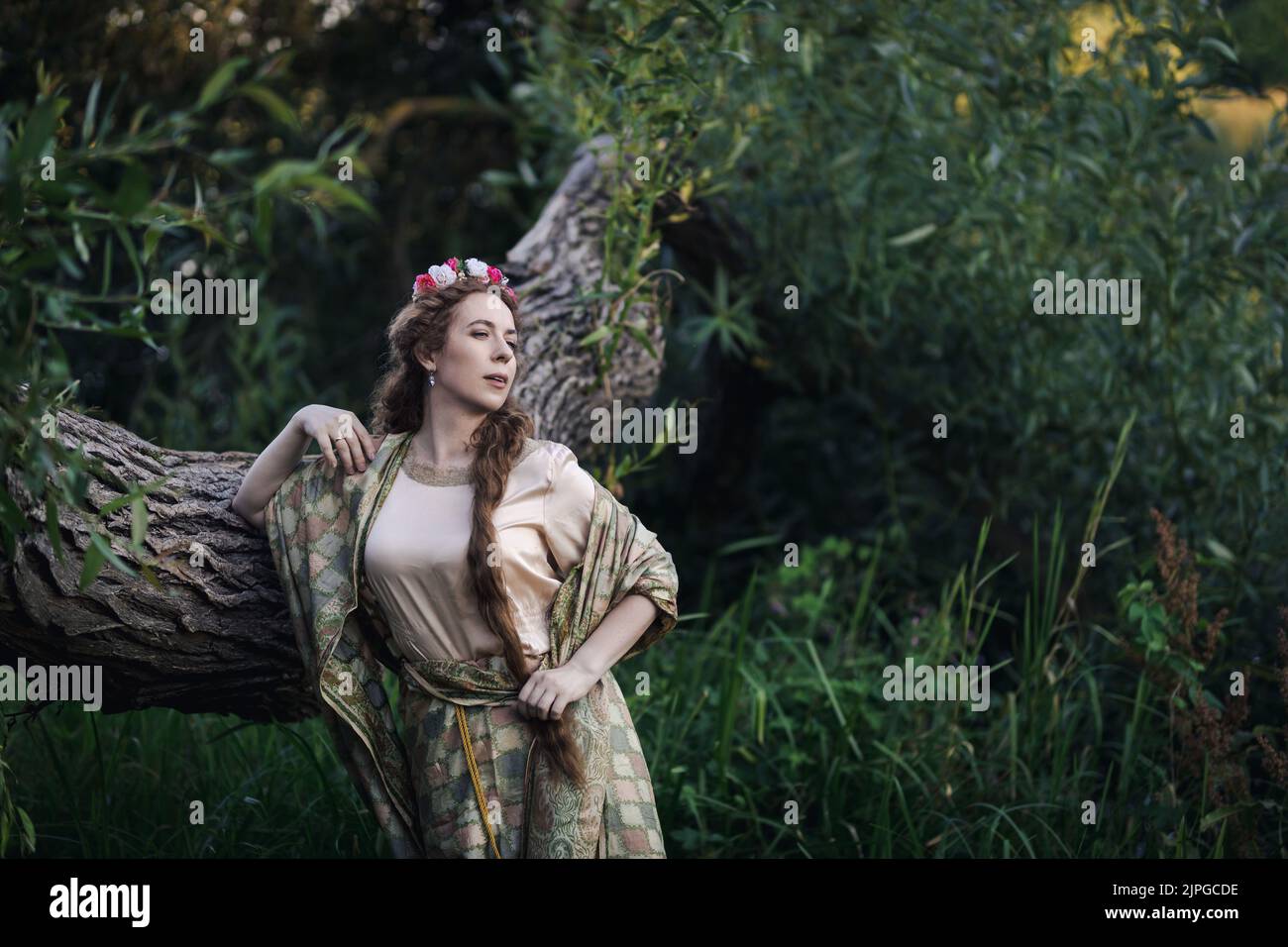 Portrait of a beautiful mature woman dressed in a nymph-style dress ...