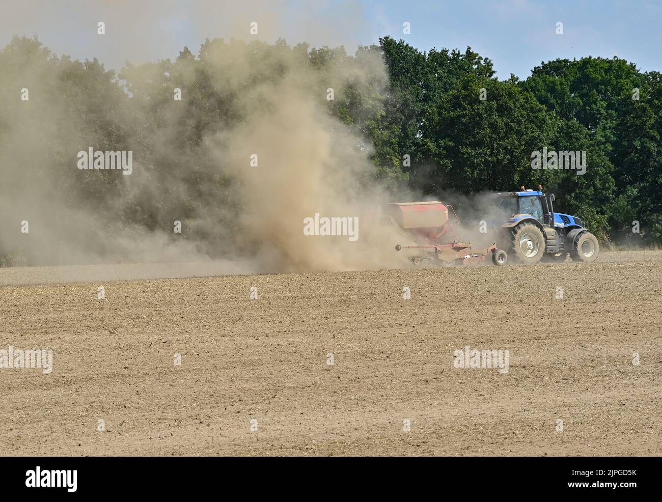 Pfaffendorf, Germany. 18th Aug, 2022. A farmer drives a tractor and a ...