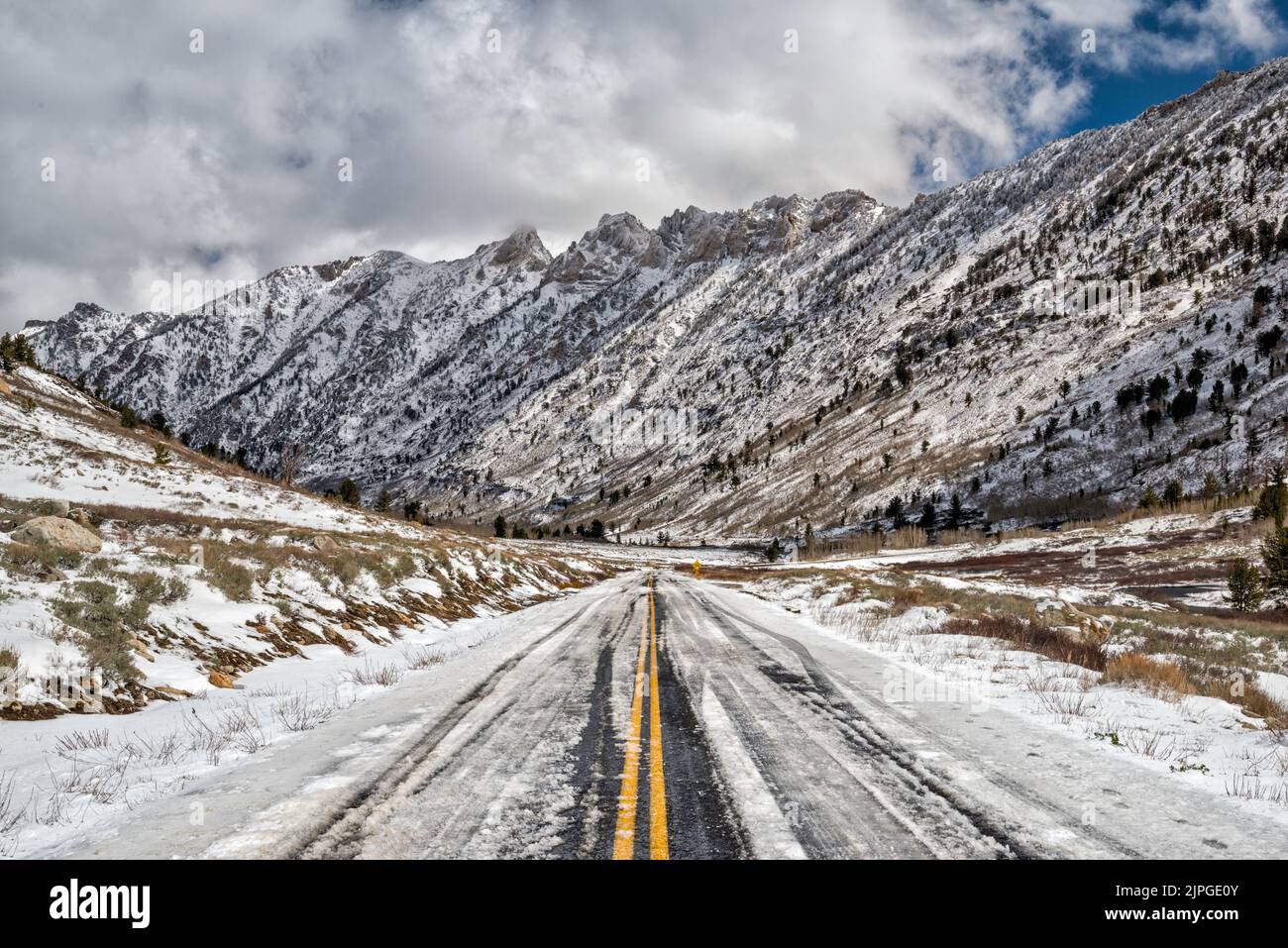 Road in Lamoille Canyon in Ruby Mountains, wheel tracks in snow, after ...