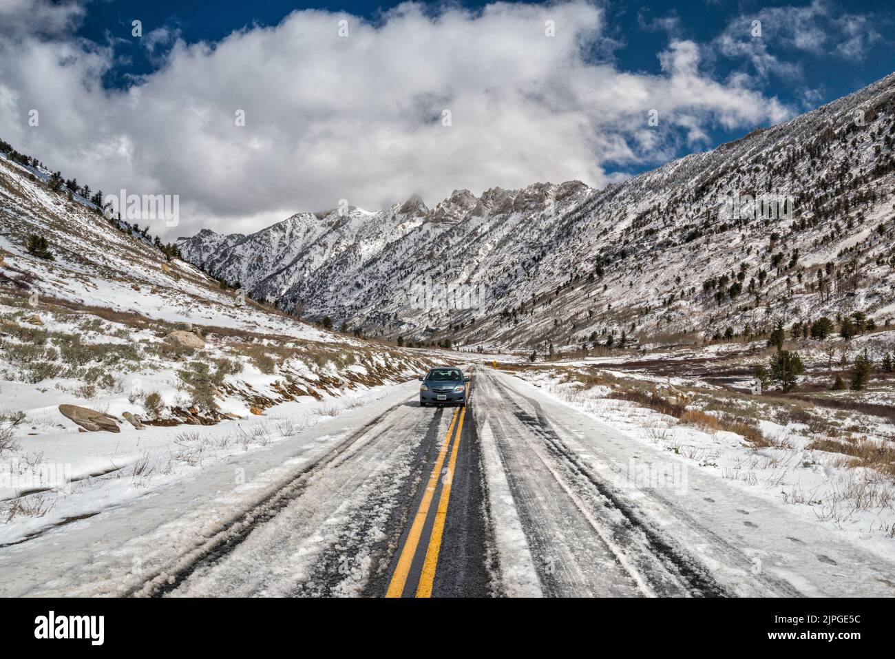 Road in Lamoille Canyon in Ruby Mountains, wheel tracks in snow, after ...