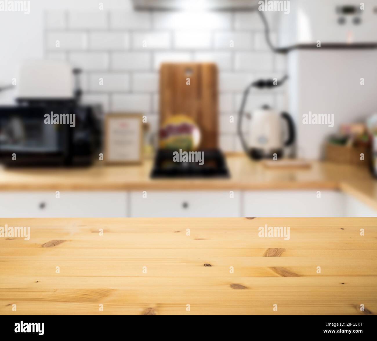 empty wooden tabletop and blurred kitchen mock up for product display ...