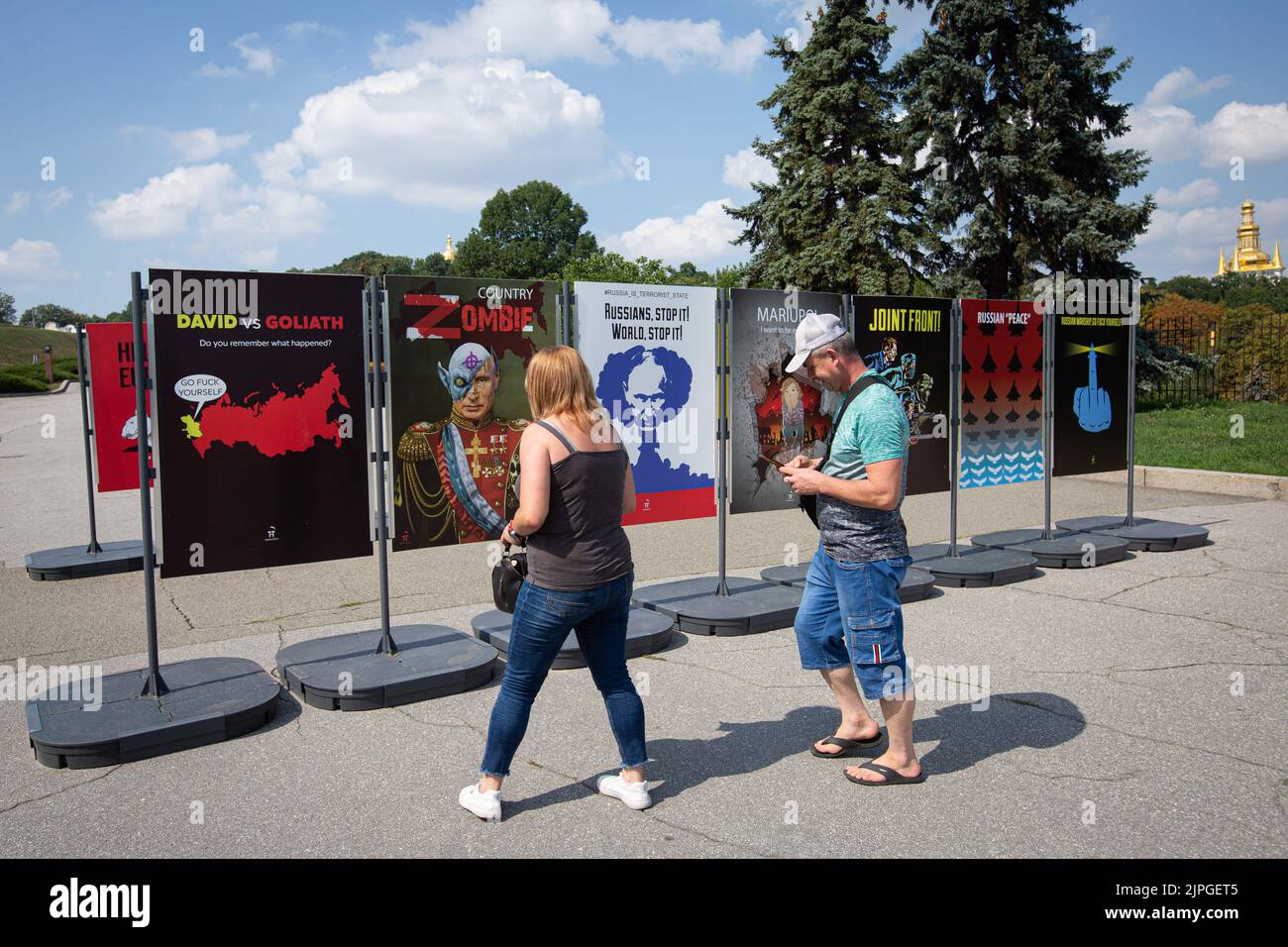 Kyiv, Ukraine. 17th Aug, 2022. People look at a poster with the ...