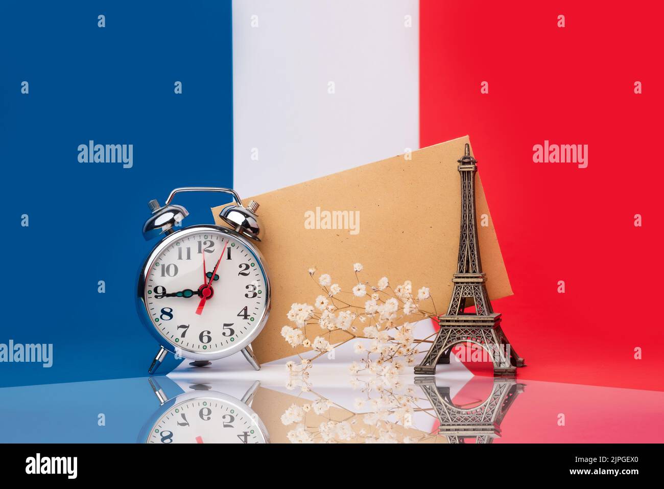 Clock and miniature of the Eiffel Tower together with an envelope to ...