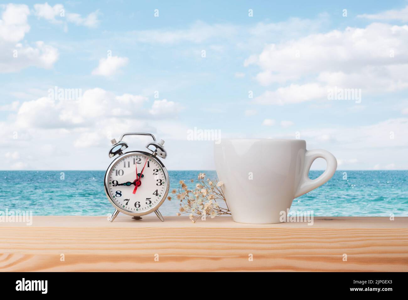 Time to relax looking at the sea. A cup of coffee and a clock that ...
