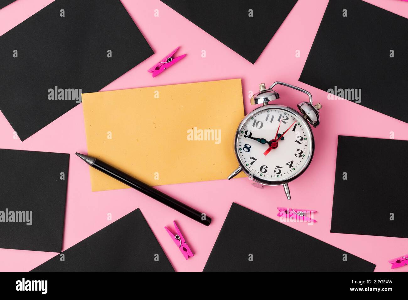 Pink background with envelopes, pencil and a clock to write notes ...