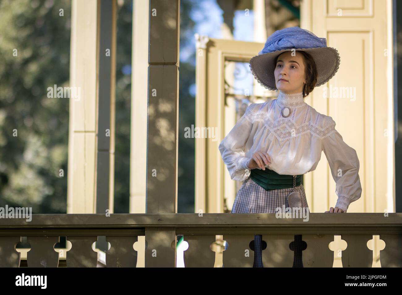 Portrait of a young slender woman in a 1910s costume. A woman in an ...