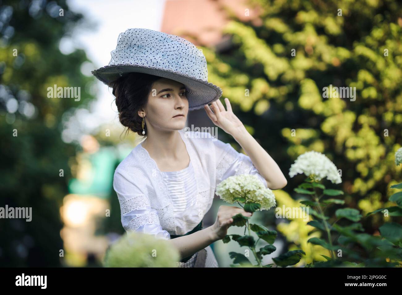 Portrait of a young slender woman in a 1910s costume. A lady in a hat ...