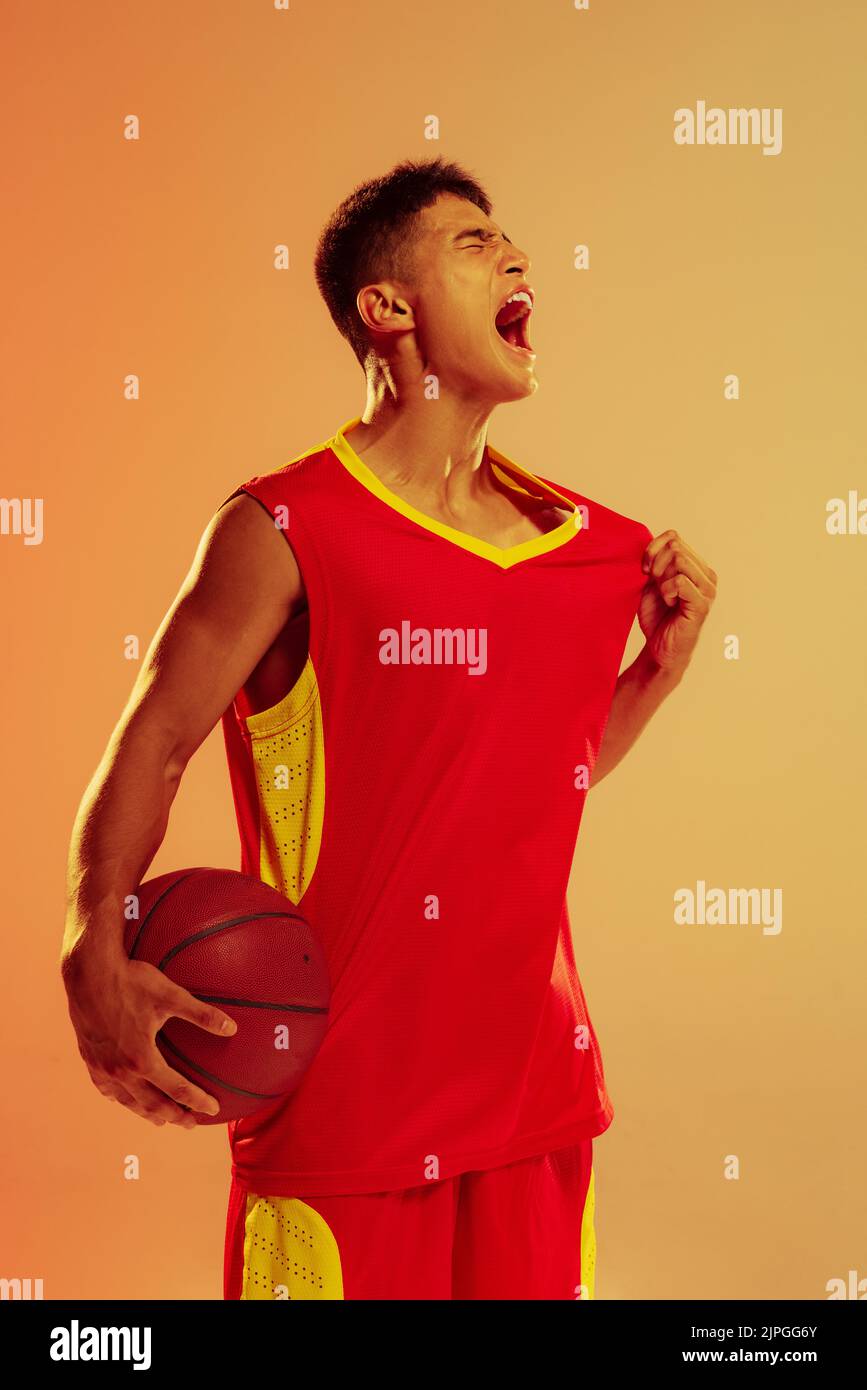 Portrait of young emotive man, basketball player emotionally screaming ...