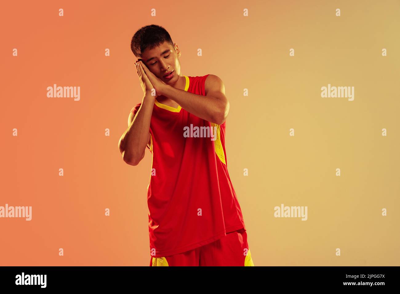 Portrait of young man, basketball player looking sleepy and tired ...