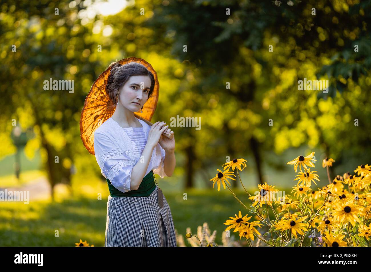 Portrait of a young slender woman in a 1910s costume. Lady walking in ...