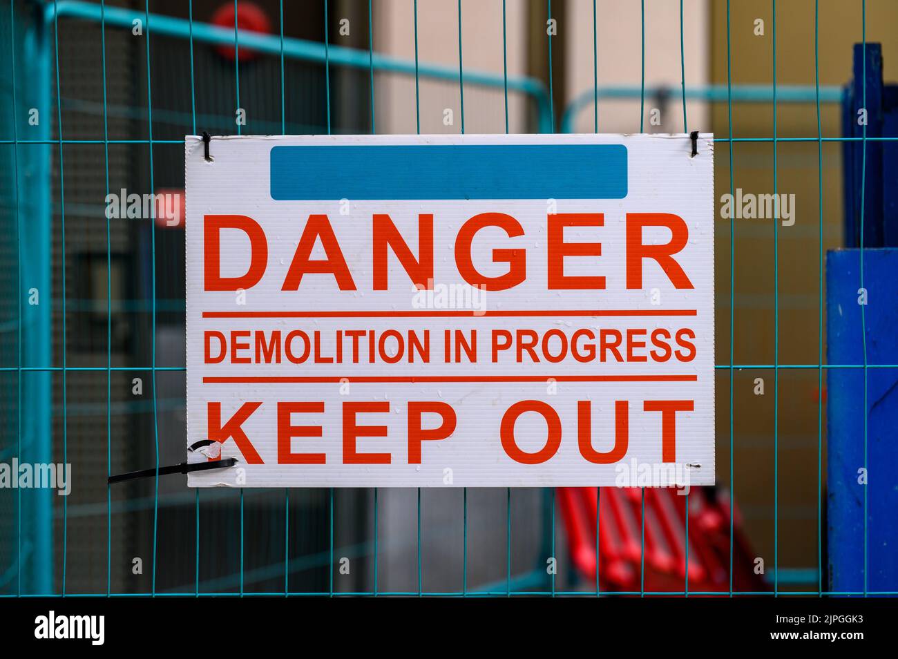 Danger Demolition in Progress Keep Out sign on metal construction fence ...