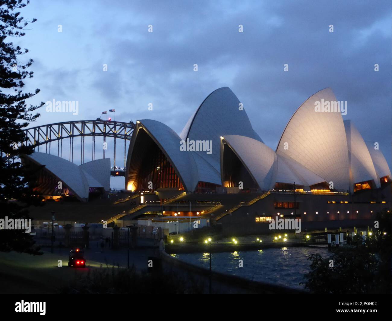 Sydney Opera House from the side angle at dusk with the Harbour Bridge ...
