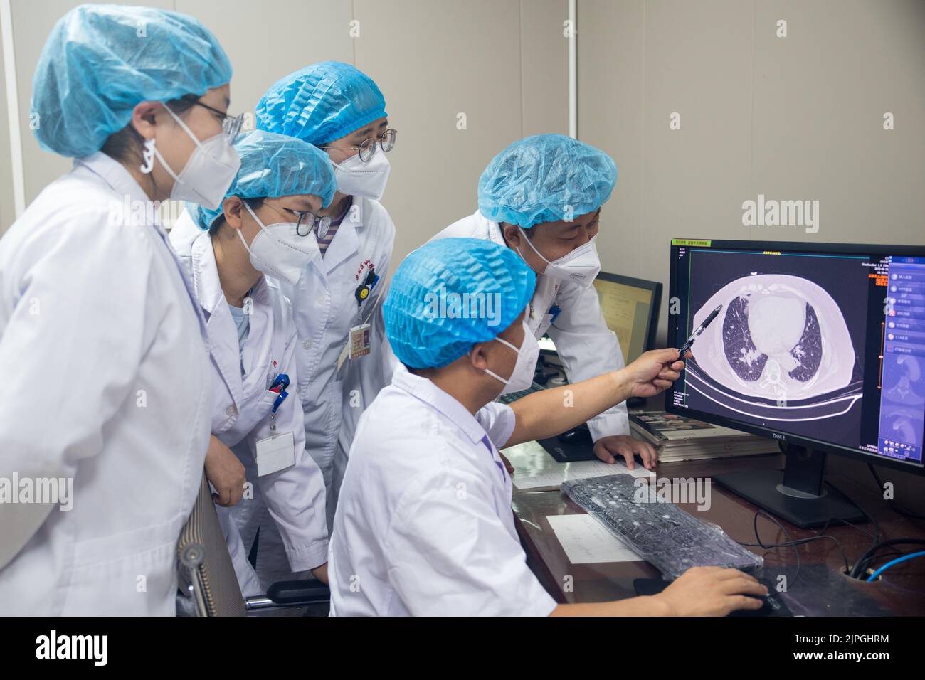 URUMQI, CHINA - AUGUST 18, 2022 - A radiologist checks a patient's ...