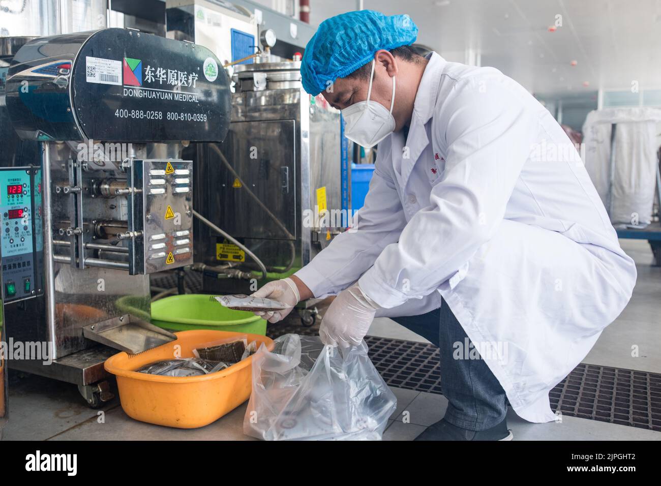 URUMQI, CHINA - AUGUST 18, 2022 - A pharmacist dispenses traditional ...