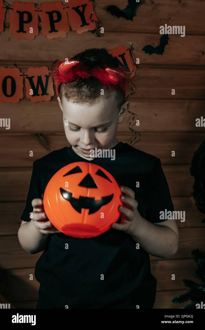 Halloween kids. Cute little boy, child in suit with orange Jack O ...