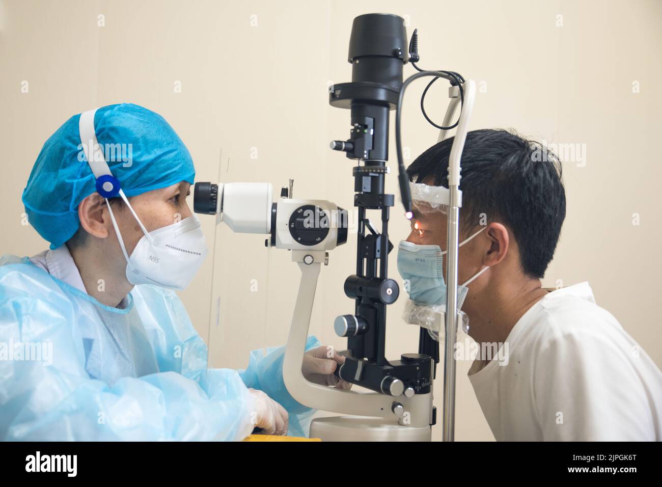 URUMQI, CHINA - AUGUST 18, 2022 - An eye doctor examines a patient's ...