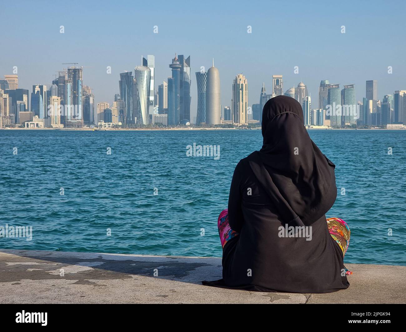 A Muslim women with abaya dress facing to Doha skyline Stock Photo - Alamy