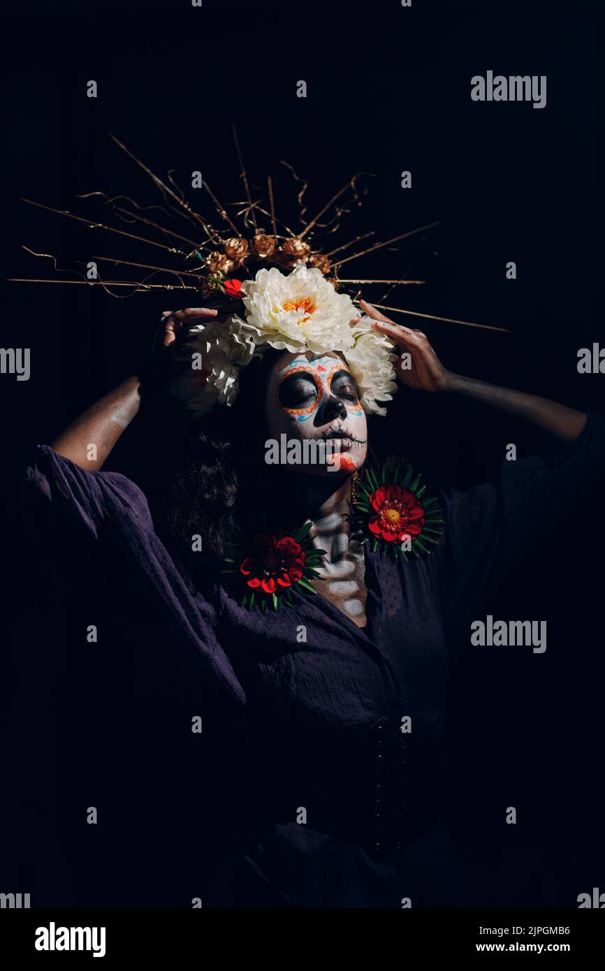 Woman with mexican skull halloween makeup on dark background. Day of ...