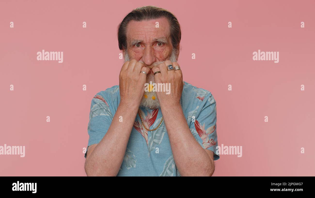 Upset scared frightened senior man biting nails, feeling worried ...