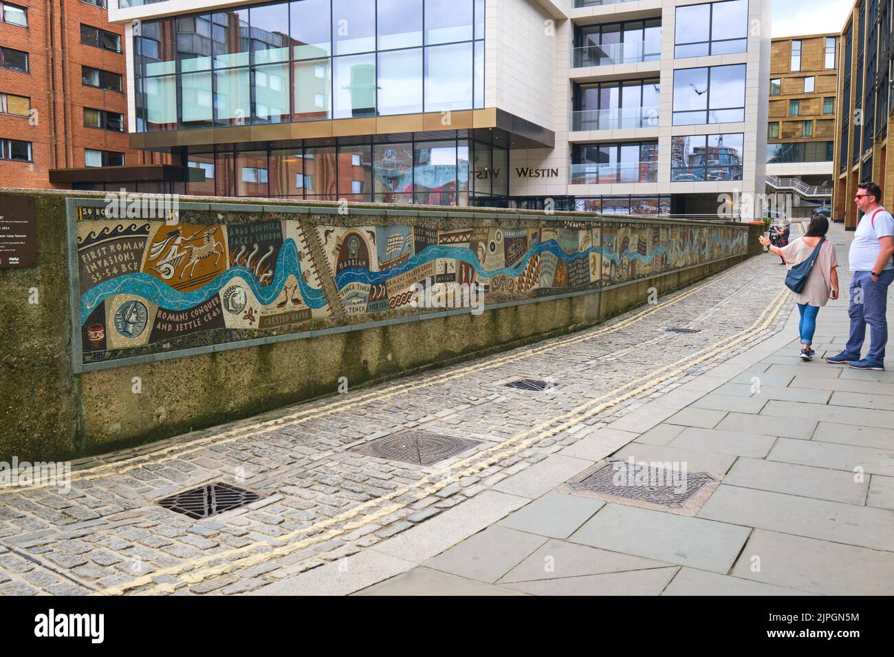 Overview of the long mosaic, mounted on a low wall. At the Queenhithe ...