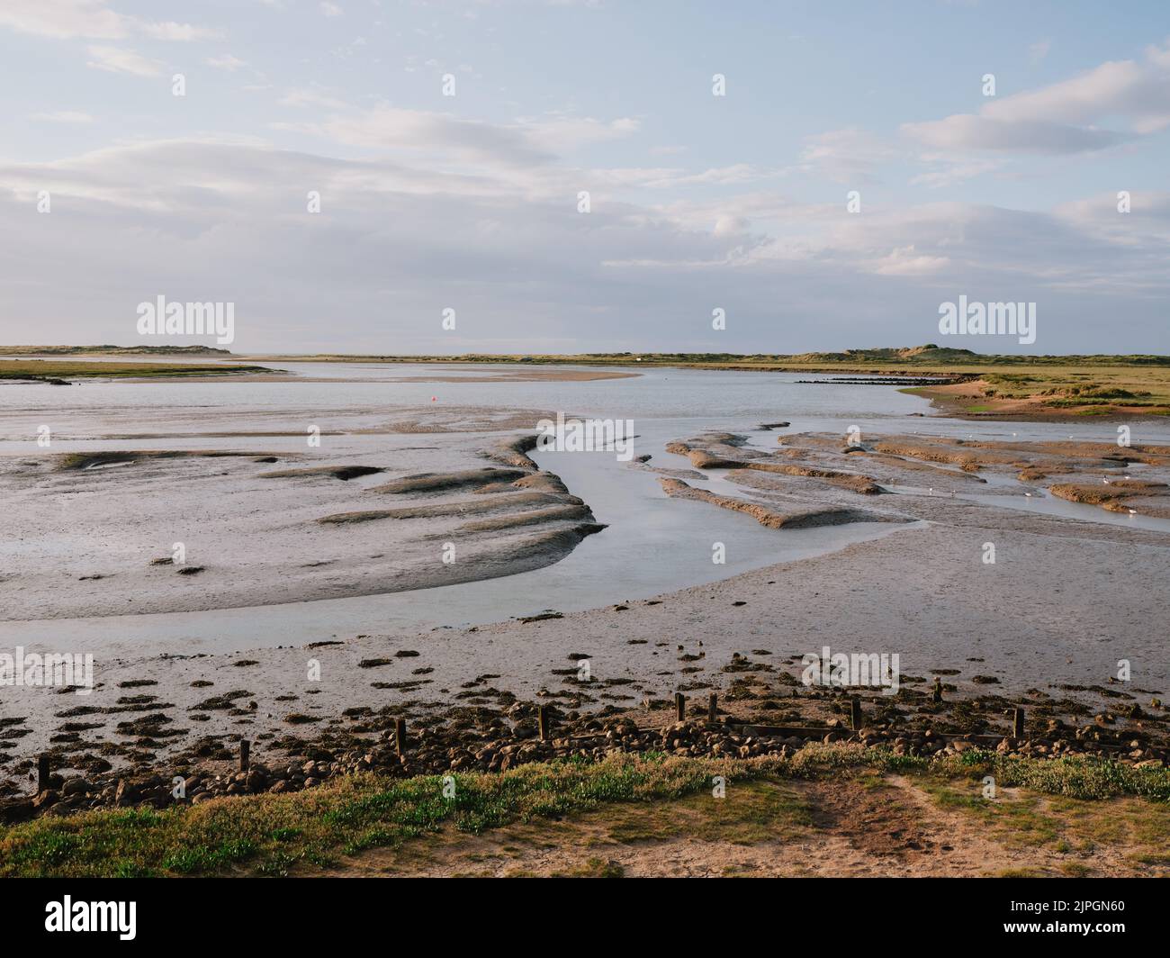 Burnham Overy summer marsh low tide mud flats landscape of the North ...