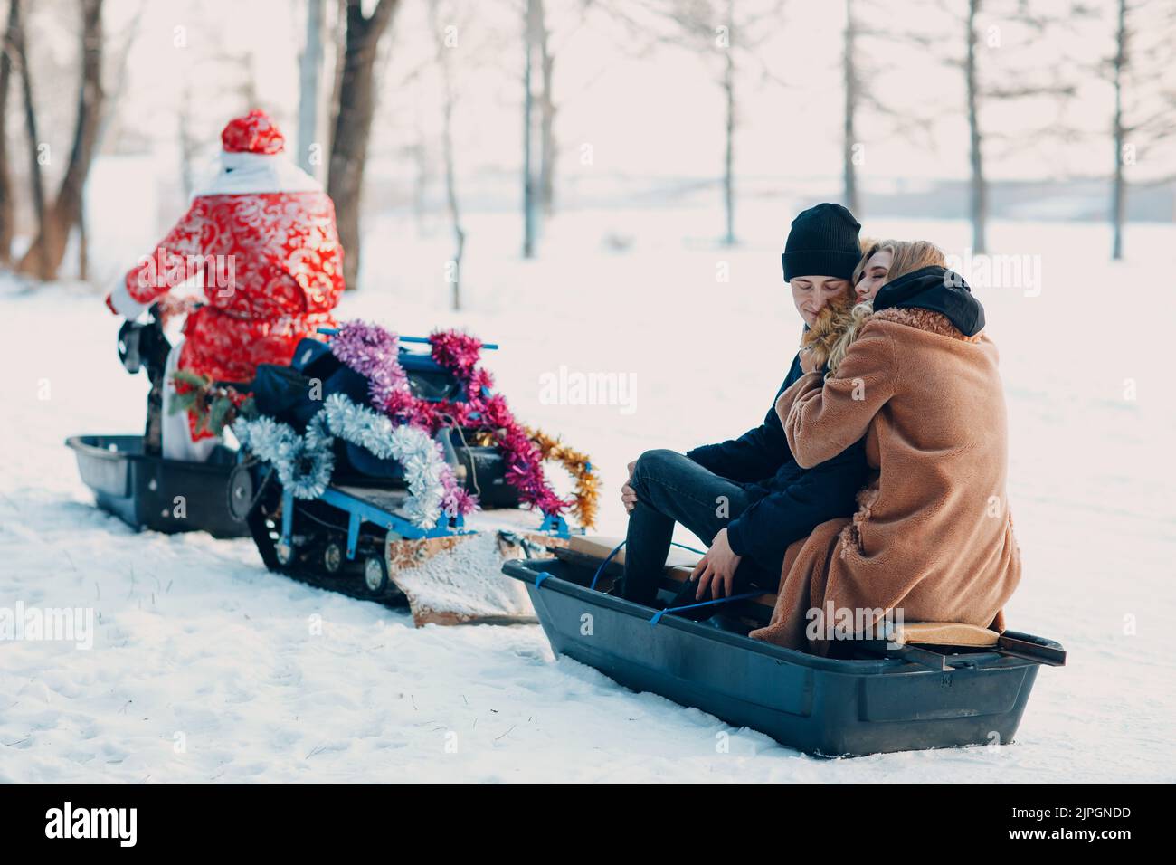 Santa claus riding snowmobile couple in love in the winter forest Stock ...