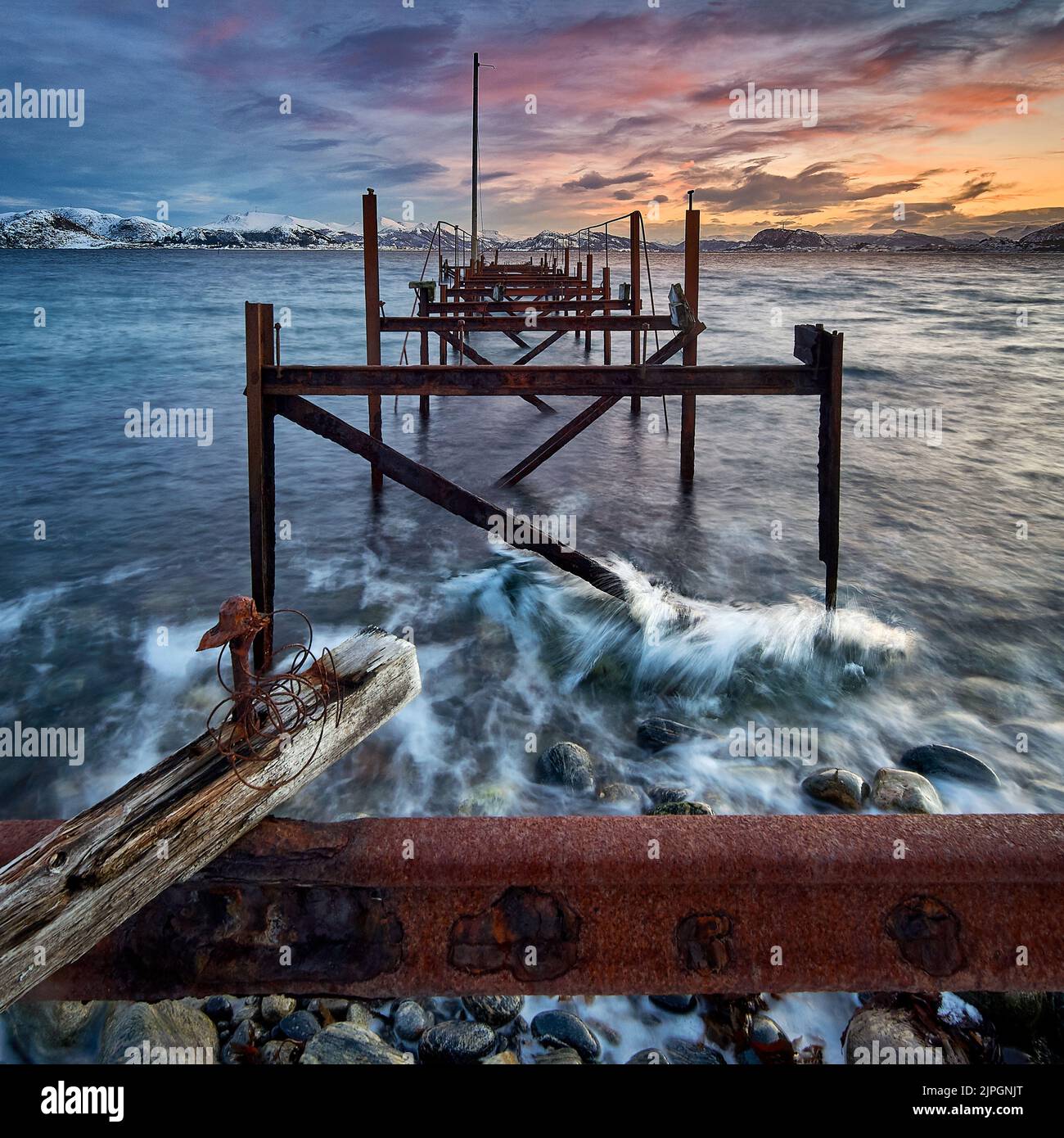 Run down jetty with gorgeous winter sunset on Godøy, Sunnmøre, Møre og ...