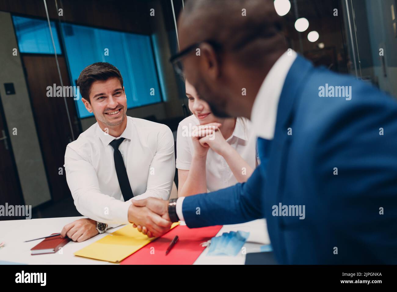 Businessman and businesswoman team handshake at office meeting ...