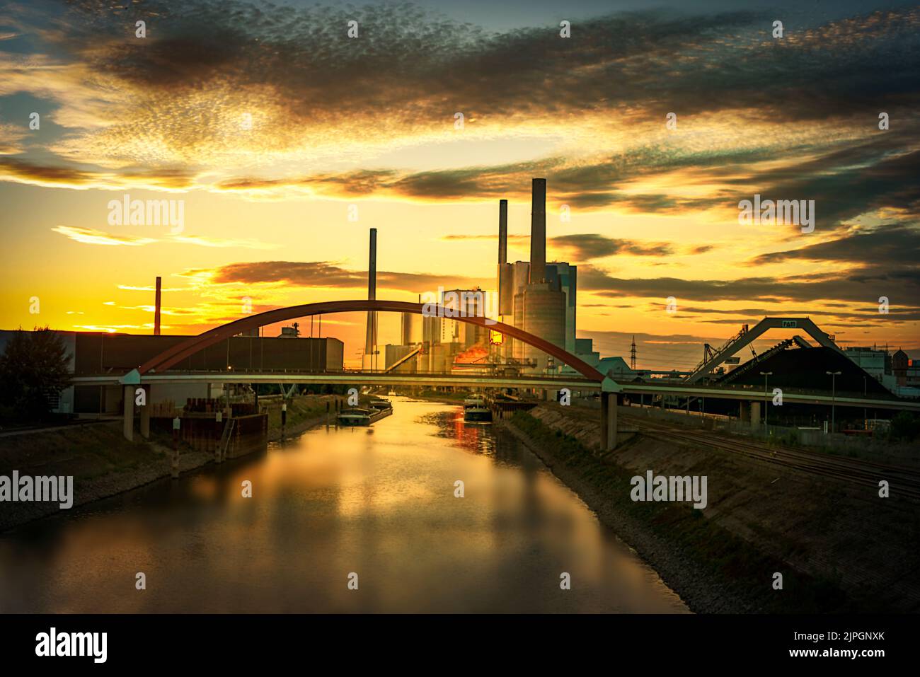 The GKM Mannheim power station with a bridge and a sunset view in the ...