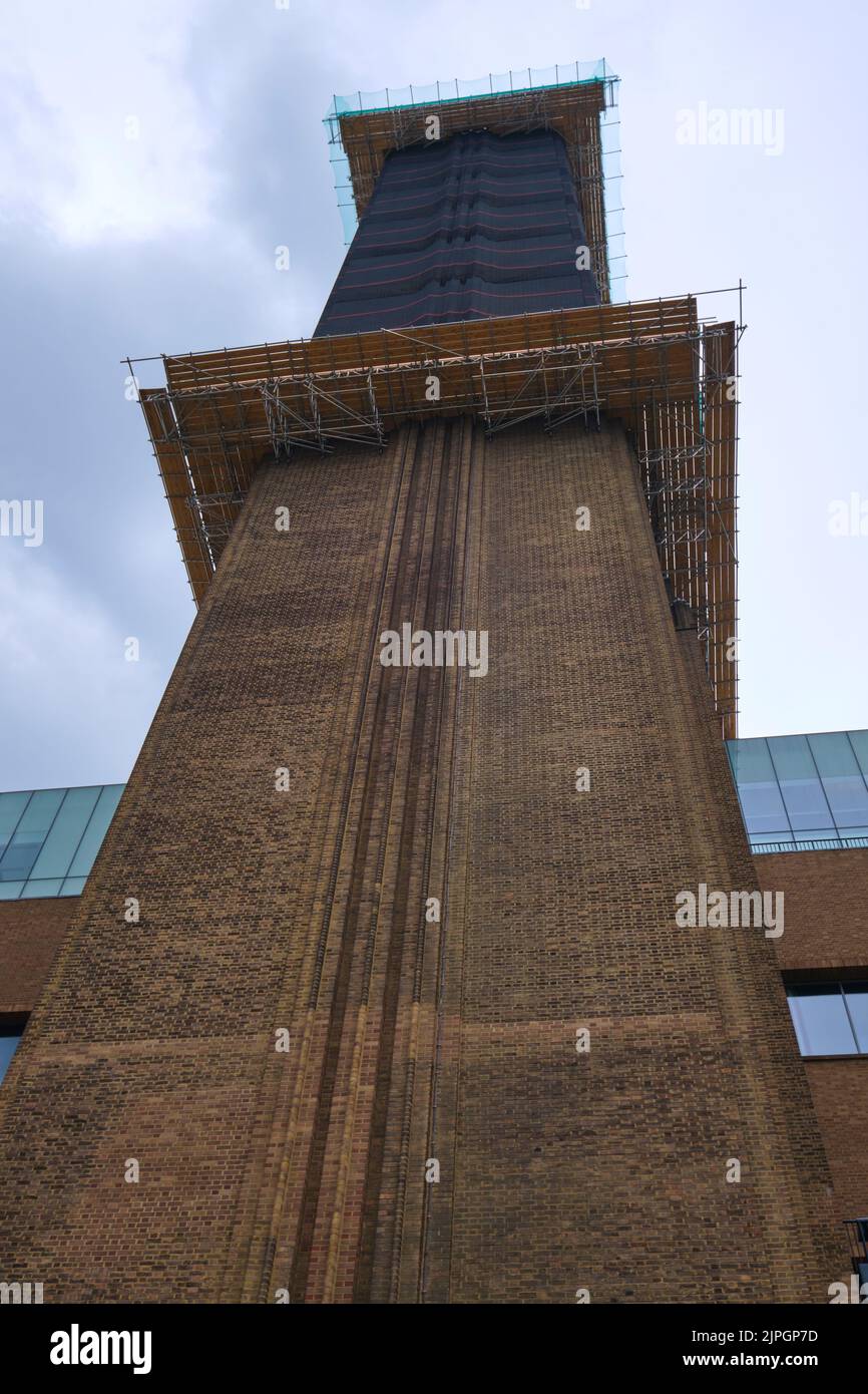 Looming view of the main smokestack brick tower, with scaffolding ...