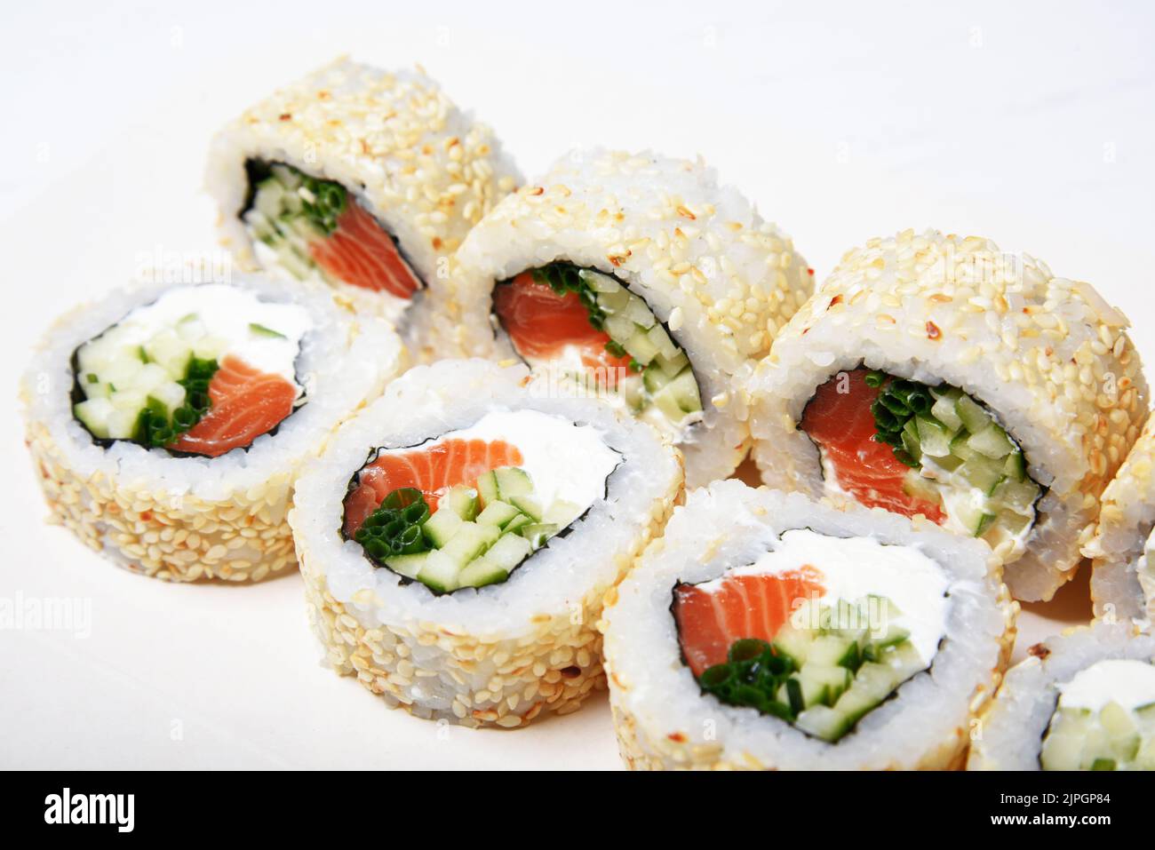 Sushi on a white background in sesame. Philadelphia with cucumber roll ...