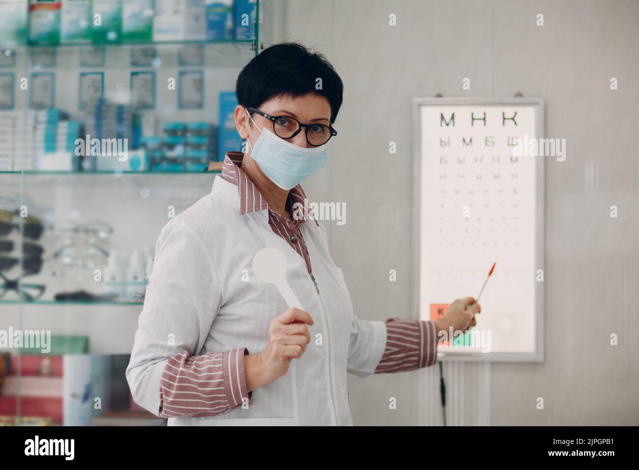 Doctor optician with letter chart for eye vision test check Stock Photo ...