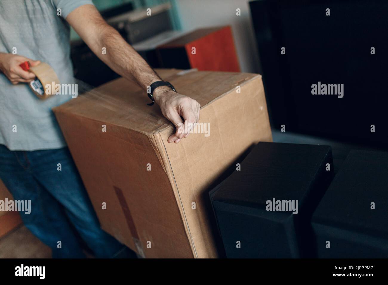 Adult man small business owner packing order box package shipping to ...