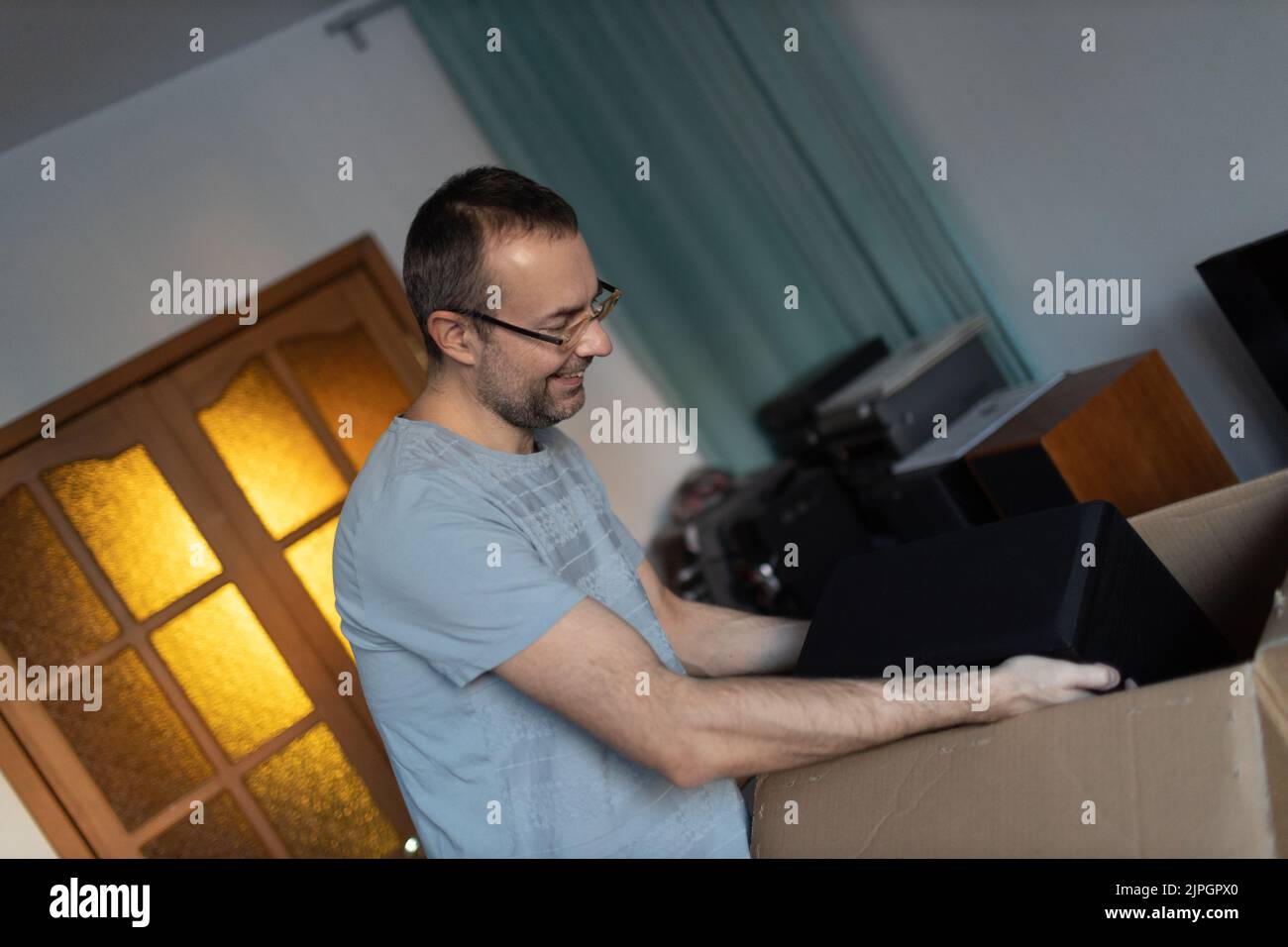 Adult man small business owner packing order box package shipping to ...