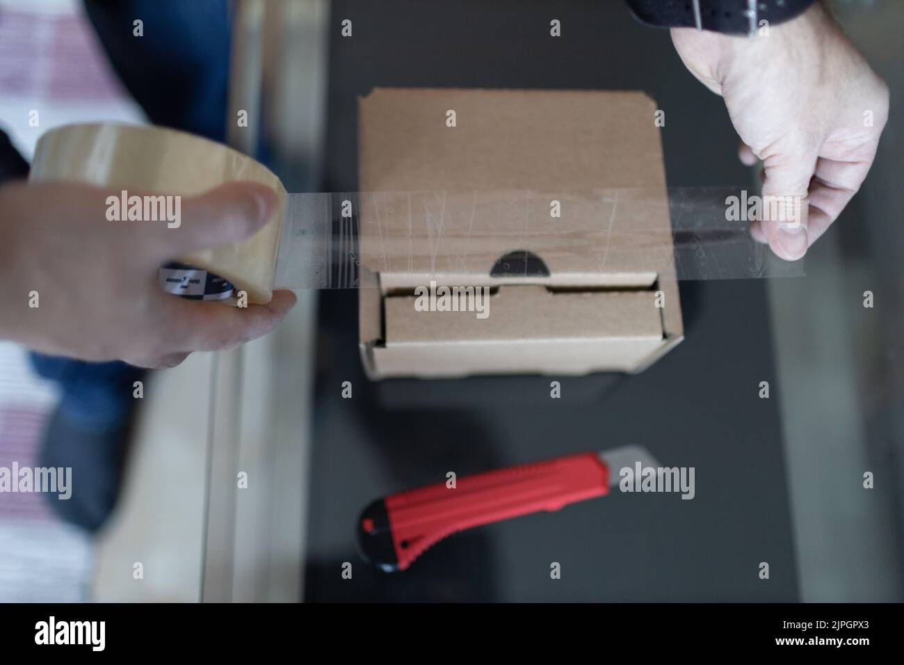 Adult man small business owner packing order box package shipping to ...