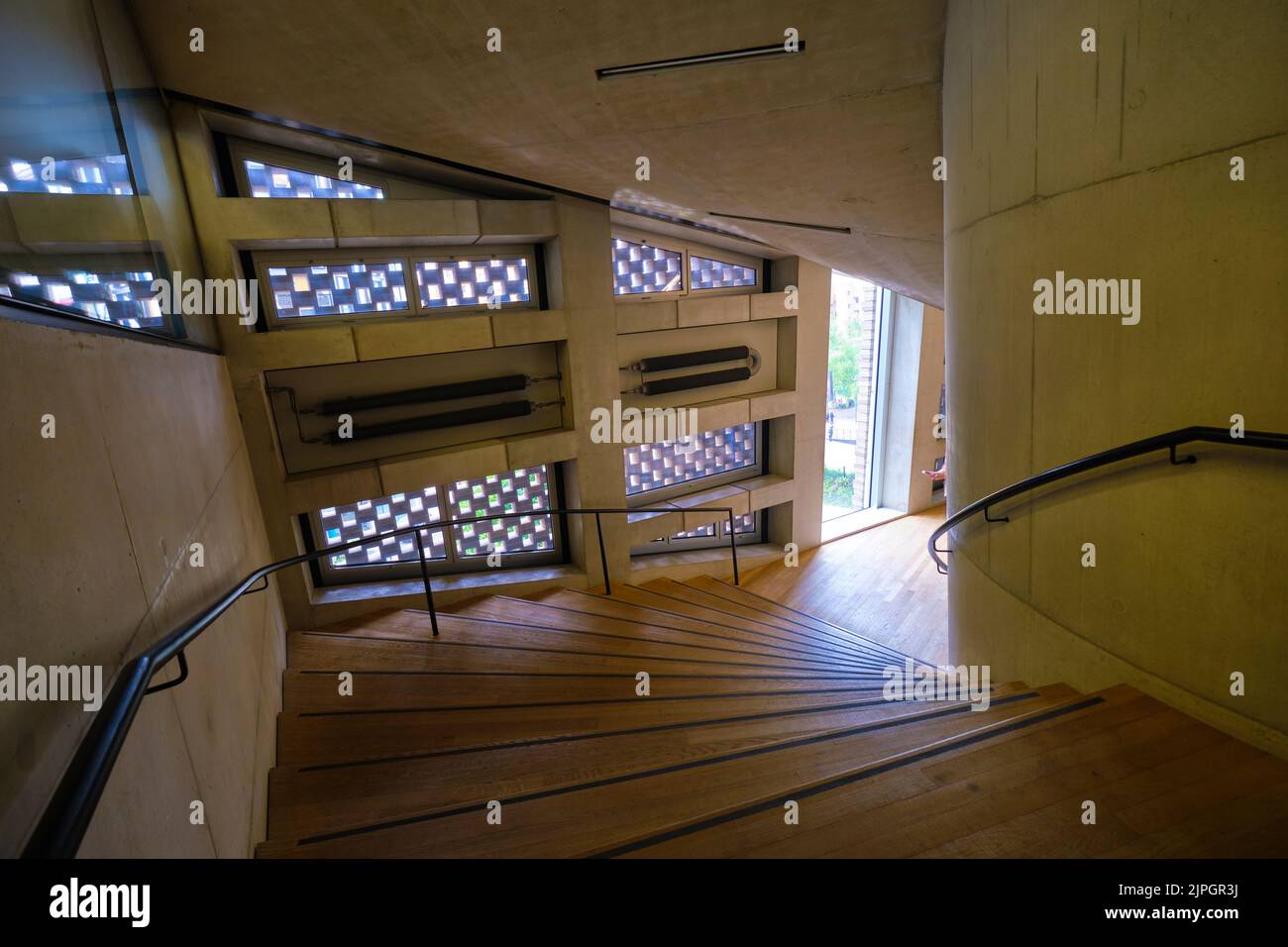A curved staircase with pinhole type of window treatment. In the Herzog ...