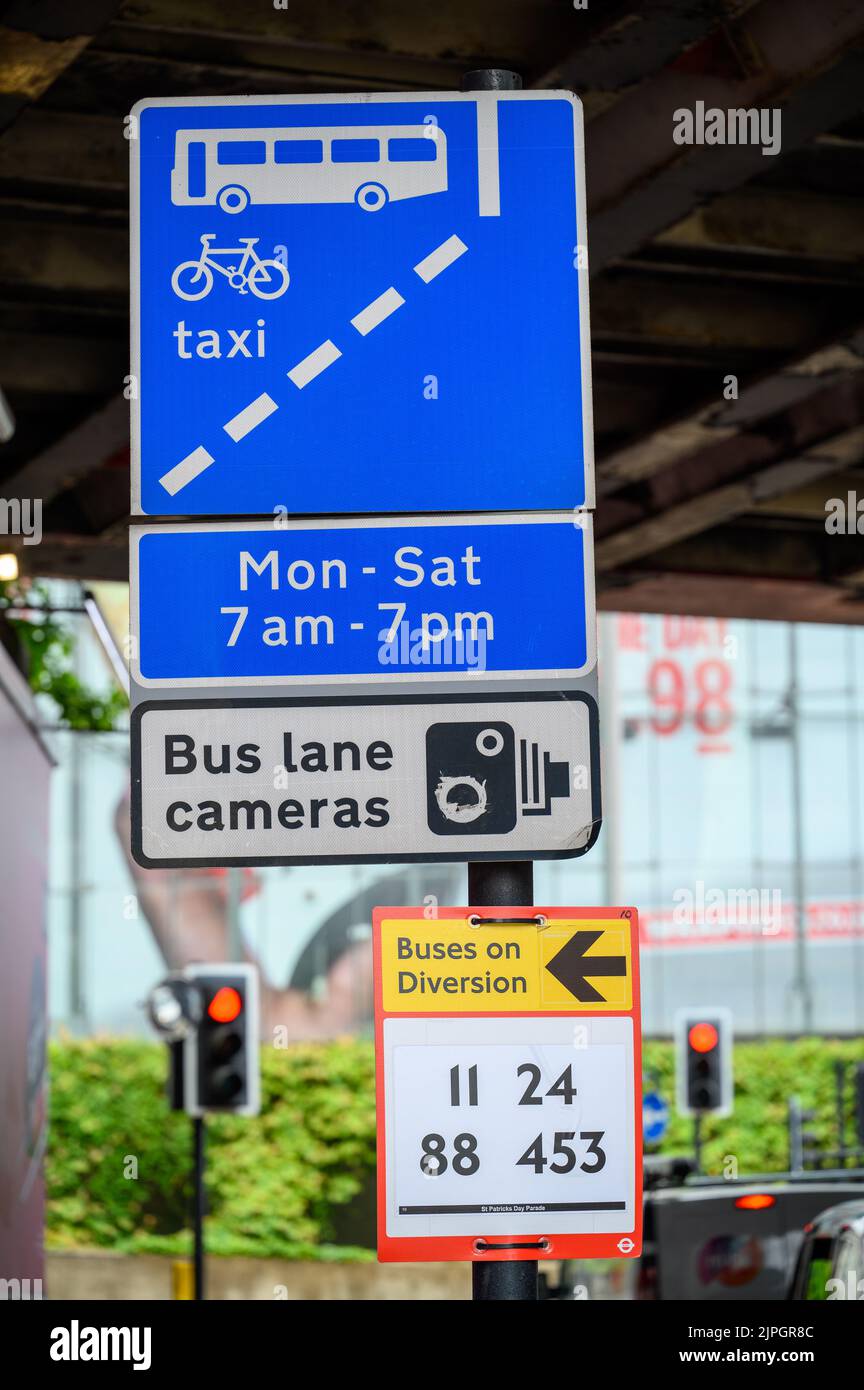LONDON - May 20, 2022: Permanent and temporary Traffic signs on post i ...